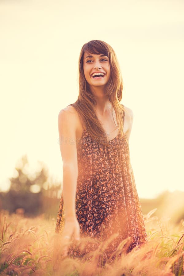 Romantic Model in Sun Dress in Golden Field at Sunset Stock Photo ...