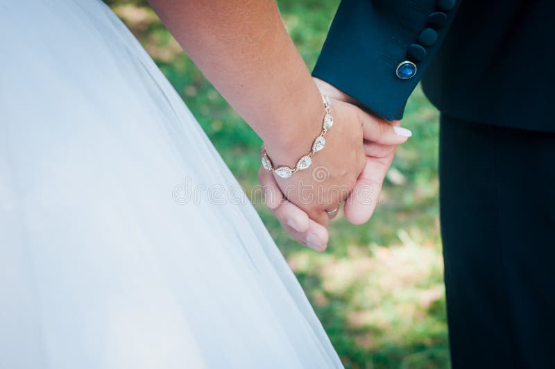 A Romantic Moment of Unity: Holding Hands in a Beautiful Outdoor ...