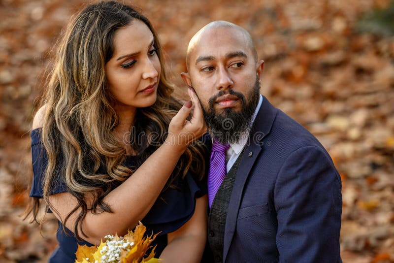 Romantic Photo Of A Well Dressed Mixed Race Couple Hugging And Holding