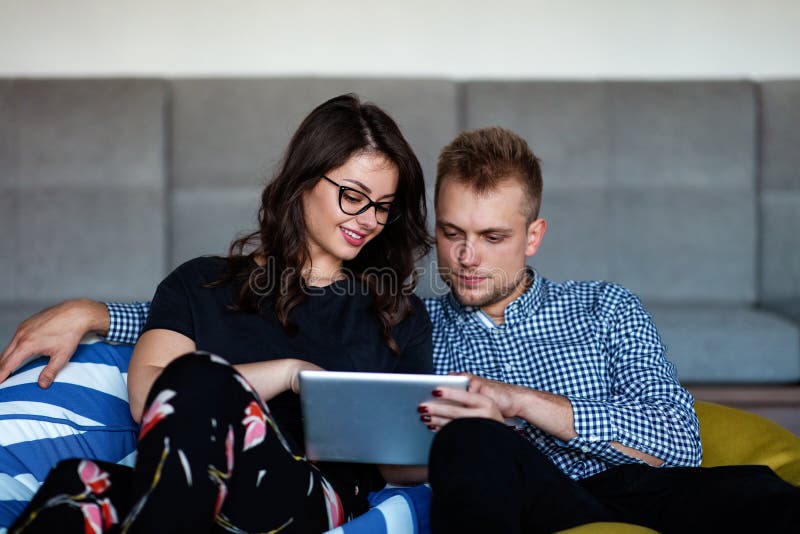 Romantic Relaxed Young Couple Using Tablet Computer on Sofa Stock Photo ...