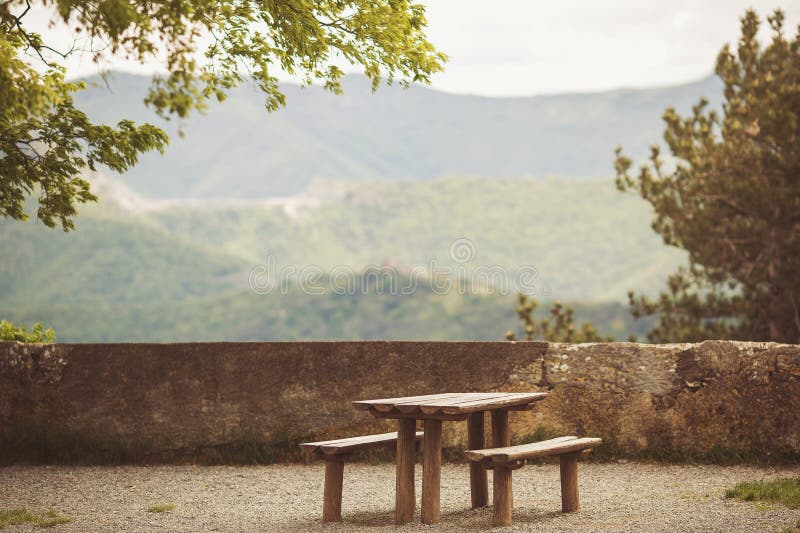 Romantic Scene with a Wooden Bench and Table in a Shadow of Trees, with ...