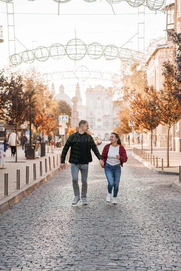 Romantic Stroll of a Happy Couple on a Cobblestone Street Stock Photo ...