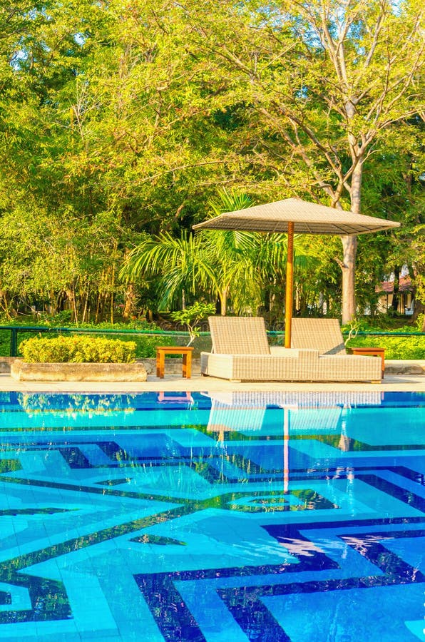 Romantic Sunbeds at the Swimming Pool Stock Photo - Image of island ...