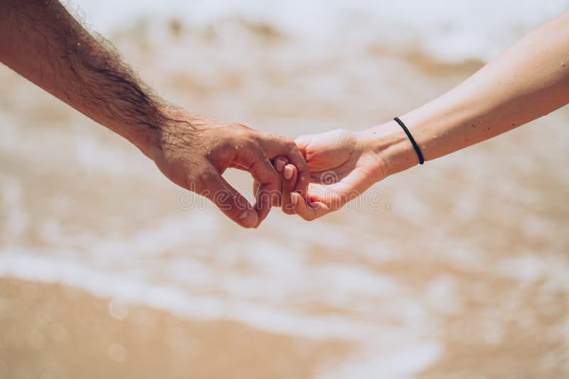 Romantic Touching Hands of a Couple in Love on the Sea Beach Stock ...