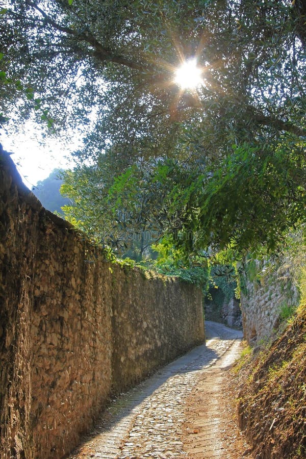 Romantic Walkway Along Brick Wall, with Bright Sunlight through Stock ...