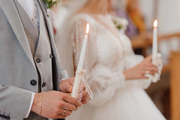 A Romantic Wedding Ceremony Scene Featuring a Bride and Groom Lighting ...