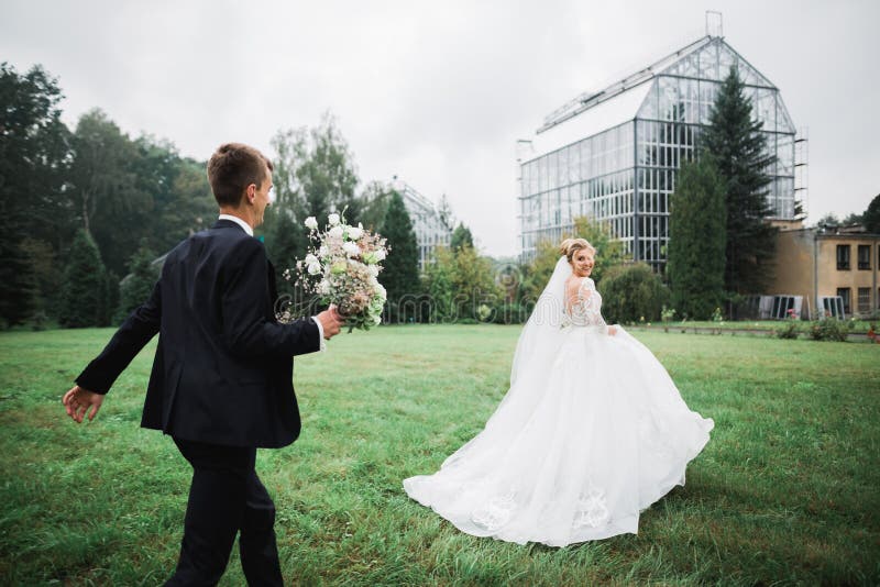 Romantic Wedding Moment, Bride Running from Groom in a Park Stock Photo ...