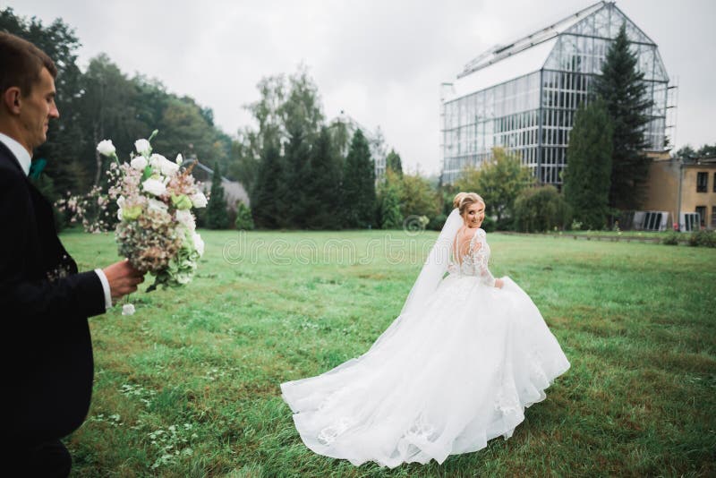 Romantic Wedding Moment, Bride Running from Groom in a Park Stock Photo ...
