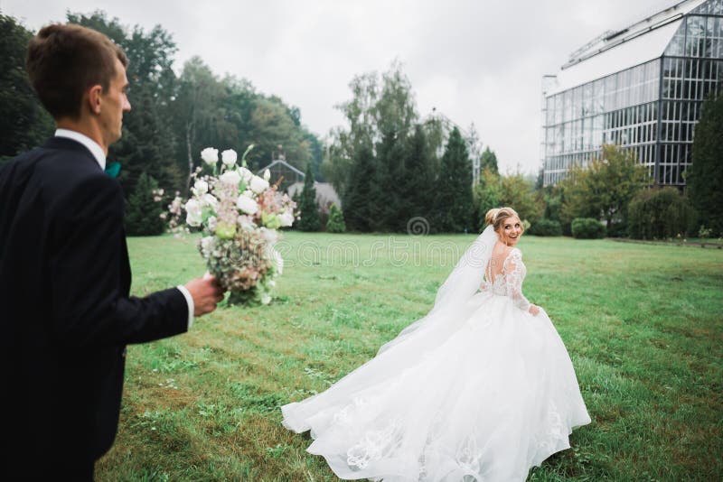 Romantic Wedding Moment, Bride Running from Groom in a Park Stock Image ...