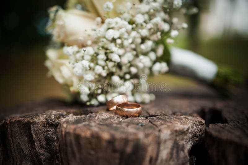 Romantic Wedding Rings and Beautiful Bouquet on Rustic Wood Stock Image ...