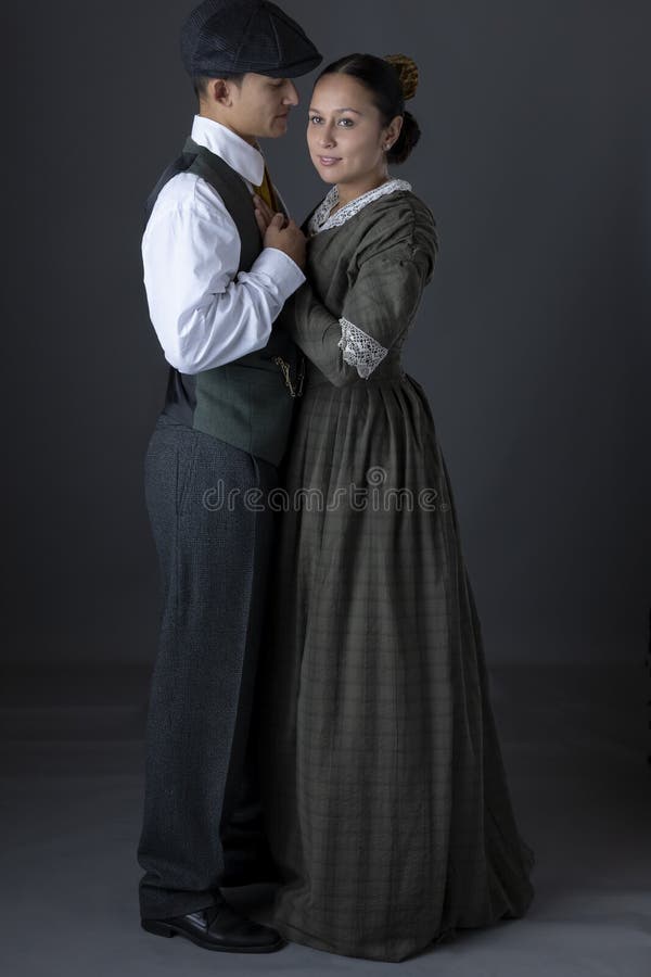 A Romantic Working Class Victorian Couple Standing Together Against a ...