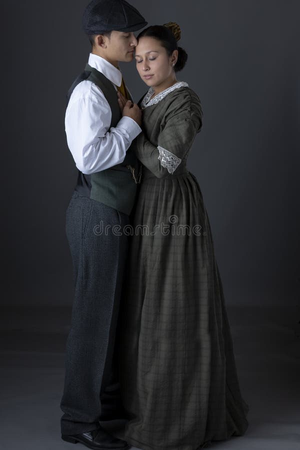A Romantic Working Class Victorian Couple Standing Together Against a ...
