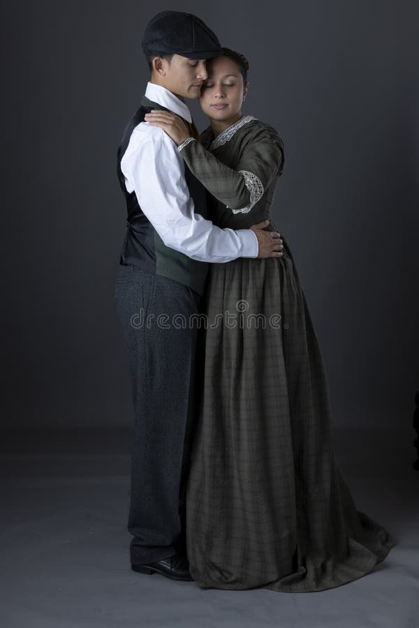 A Romantic Working Class Victorian Couple Standing Together Against a ...