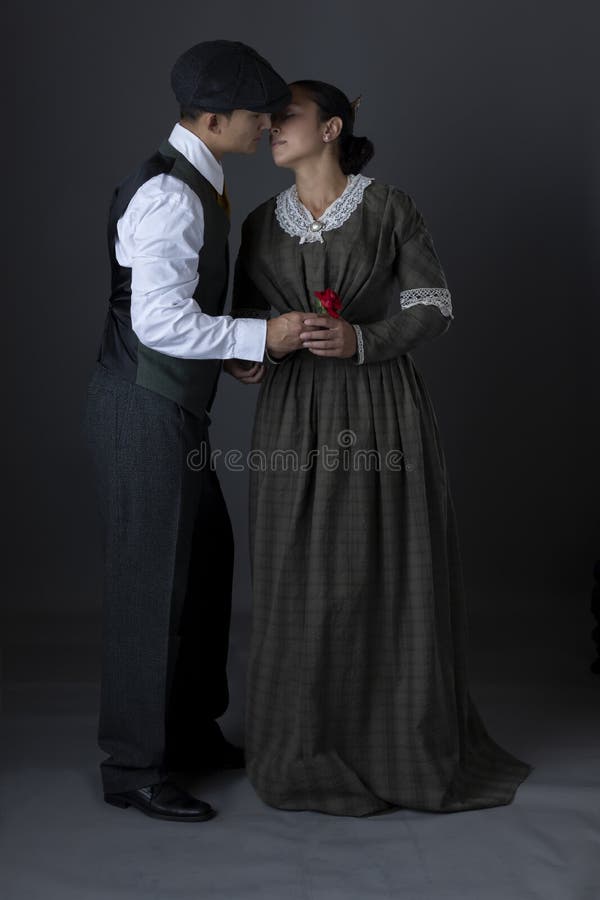 A Romantic Working Class Victorian Couple Standing Together Against a ...