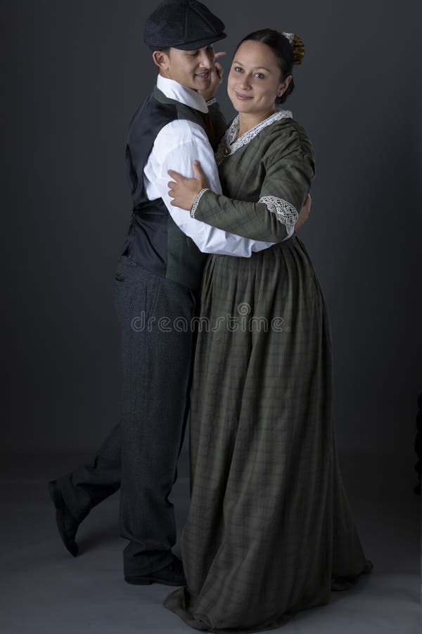 A Romantic Working Class Victorian Couple Standing Together Against a ...