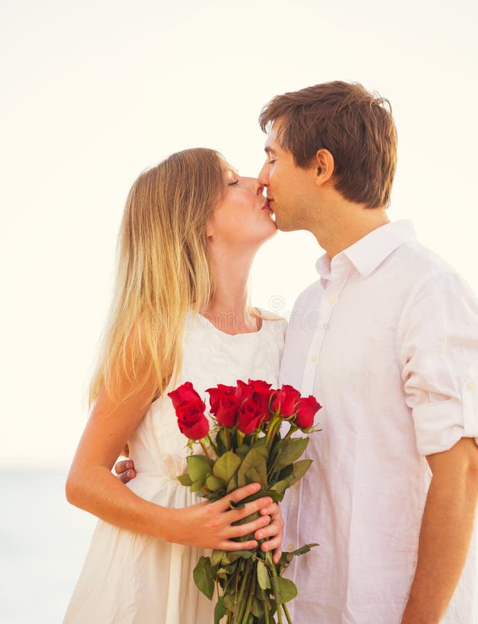 Romantic Young Couple In Love Man Holding Surprise Bouquet Of R Stock