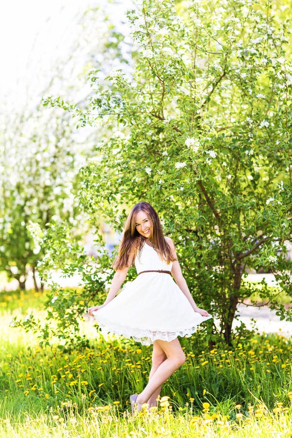Romantic Young Woman in the Spring Garden among Apple Blossom. Stock ...