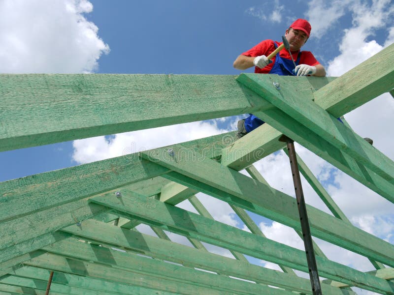 Hispanic Carpenter Lifting Roofing Panels Onto Roof Stock Image - Image ...
