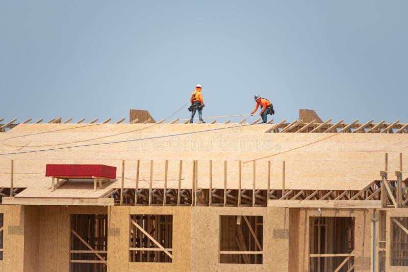Roof Construction. Roofer on Roof Structure. Construction Worker on Top ...