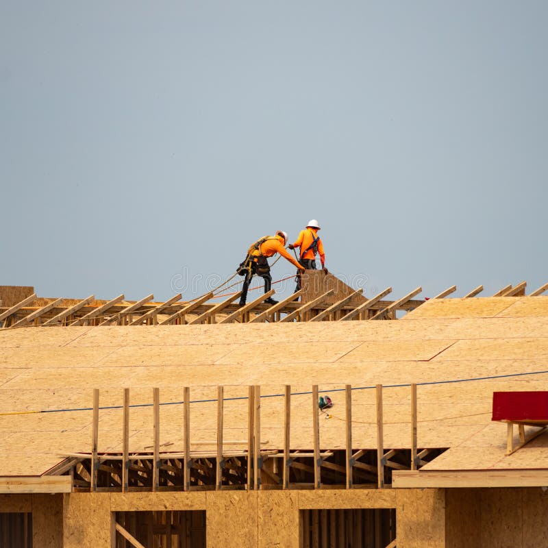 Roof Construction. Roofer on Roof Structure. Construction Worker on Top ...