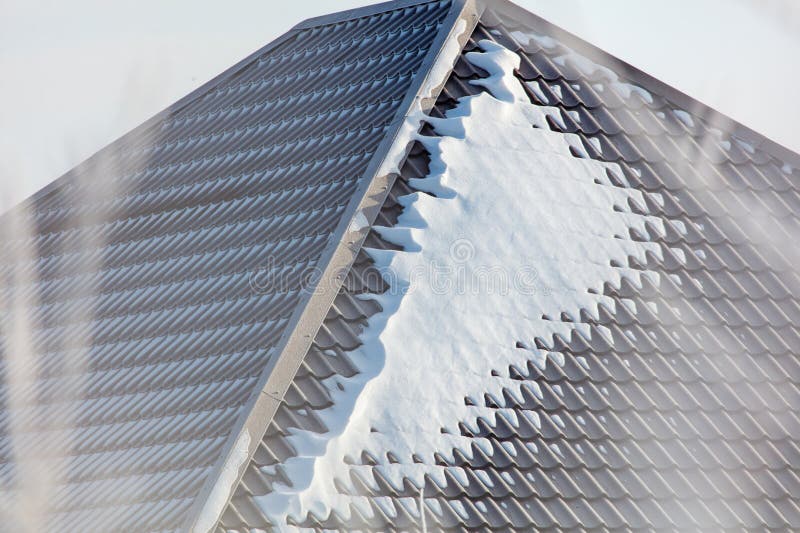 A Roof Covered in Snow with a Triangle Shaped Area of Snow Missing ...