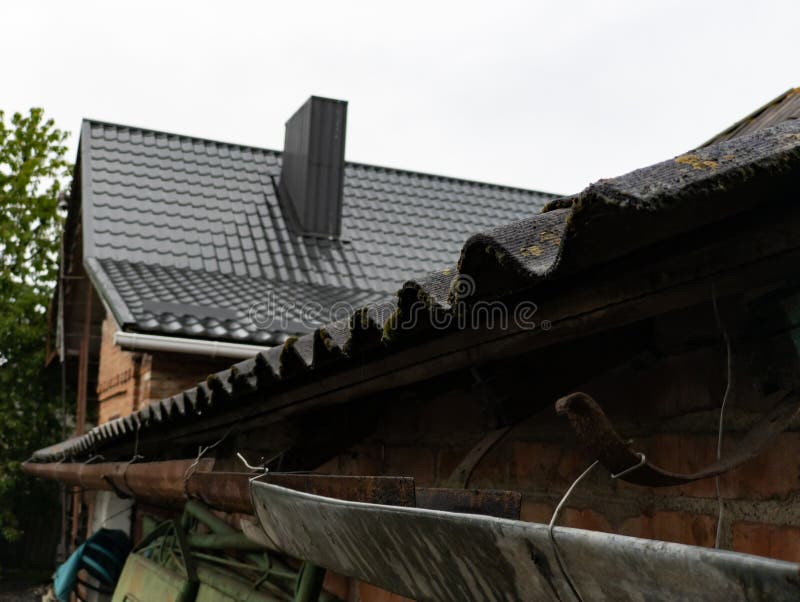 A Roof with a Metal Gutter on the Side of a Brick Building Stock Photo ...