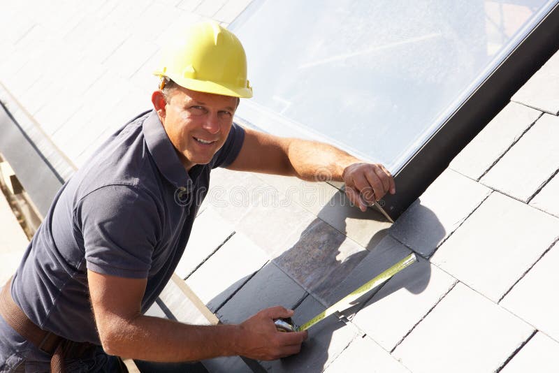 Male roofer fitting tiles stock image. Image of building - 20843229