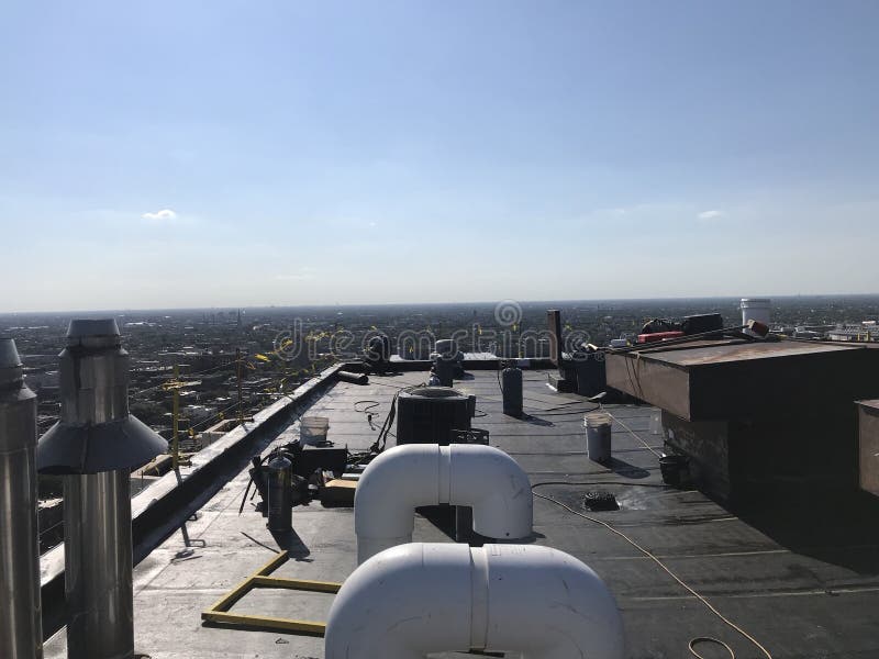 Roofer Working on a Smooth Modified Flat Roof on Commercial Building ...