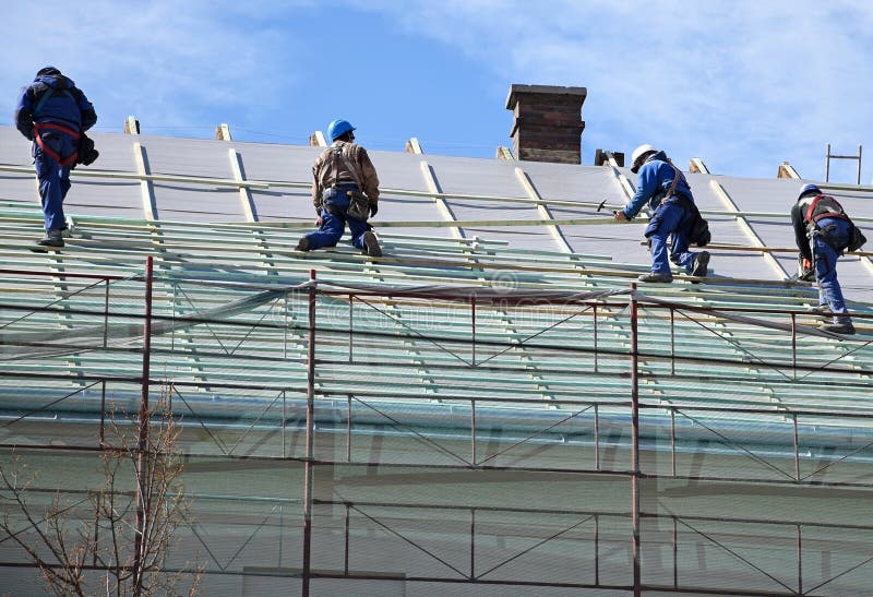 Two roofers at work stock image. Image of cladding, insulation - 16264003