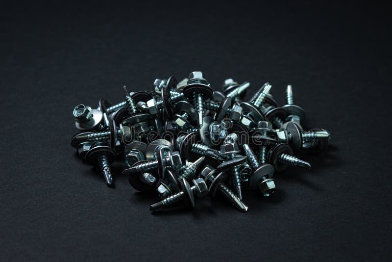 Roofing Screws on a Black Background. Metal Building Material Stock ...