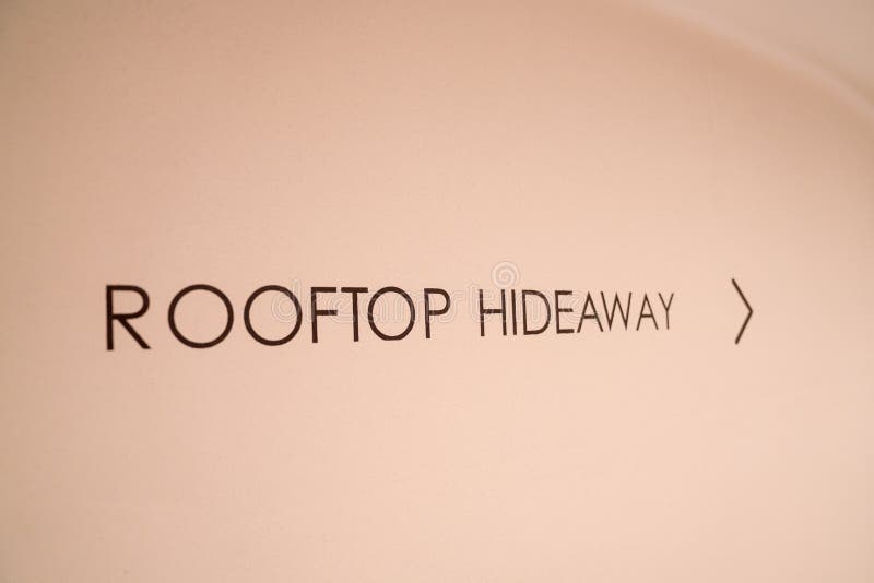 Rooftop Hideaway Sign on a Wall Stock Photo - Image of wall, smooth ...