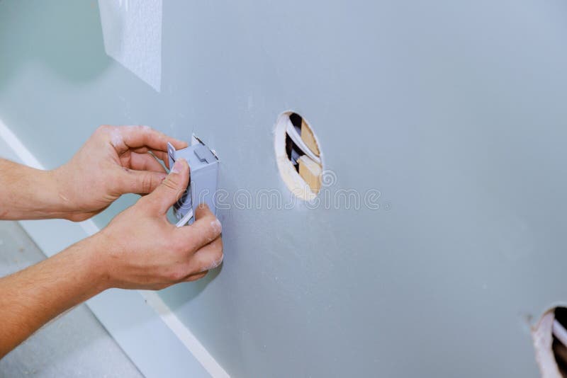 When a Room is Being Repaired, an Electrician Installs Plastic Box for ...