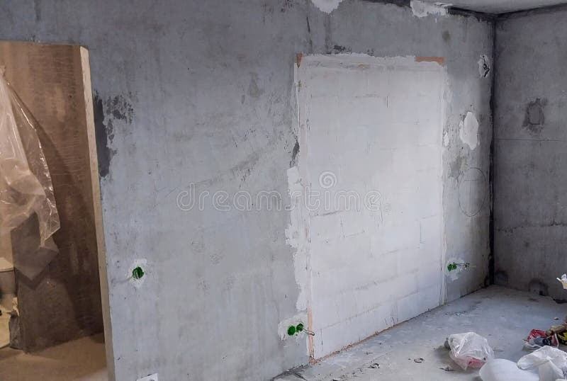 A Room Under Renovation, Showcasing Raw Concrete Walls and Construction Materials. Stock Image ...