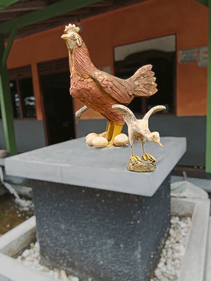 Rooster statue in a pond stock image. Image of pond - 260425121