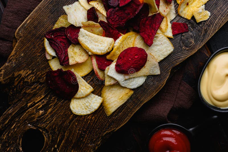 Root Vegetable Crisps, on Black Wooden Table Background, Top View Flat ...