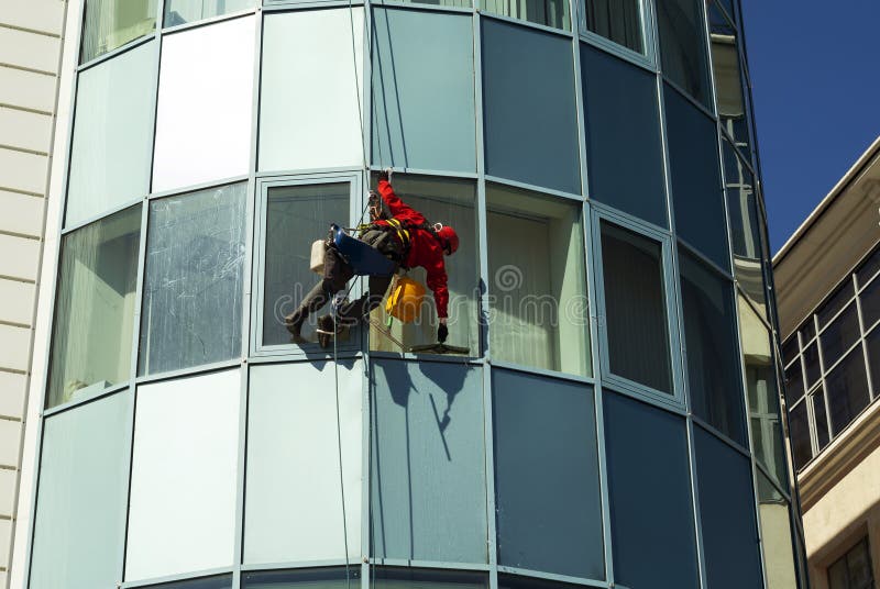 Rope Access Technician Washes Windows on the Facade of a High-rise ...