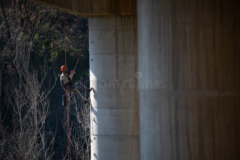 Rope Access Technician Inspecting Bridge Pylon Using Rappelling ...