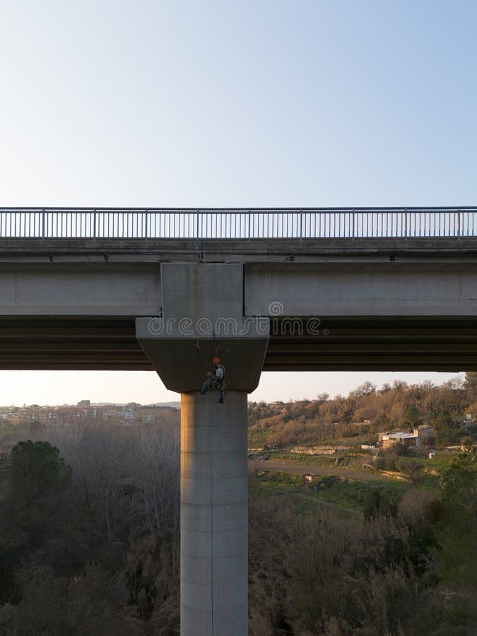 Rope Access Technician Inspecting Concrete Bridge Infrastructure at ...