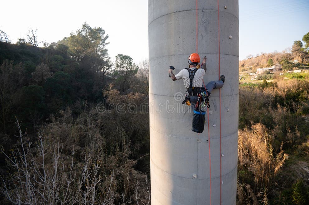 Rope Access Technician Inspecting Concrete Bridge Pillar Using Climbing ...