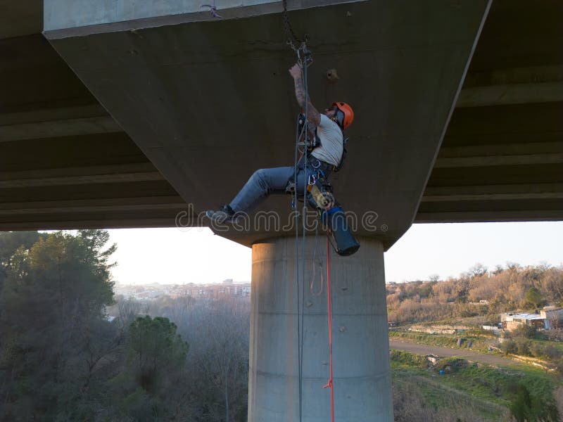 Rope Access Technician Inspecting Underside of Concrete Bridge ...
