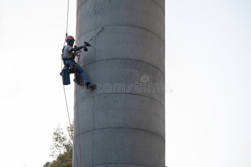 Rope Access Technician Installing Anchorages on Concrete Chimney Stock ...