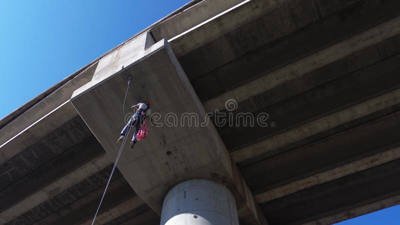 Professional Rope Access Technician Inspecting Concrete Bridge from ...