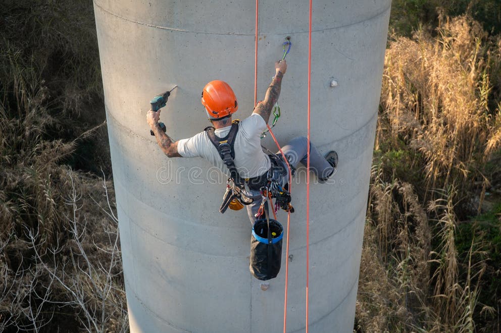Rope Access Technician Working on Concrete Chimney Using Drill Stock ...