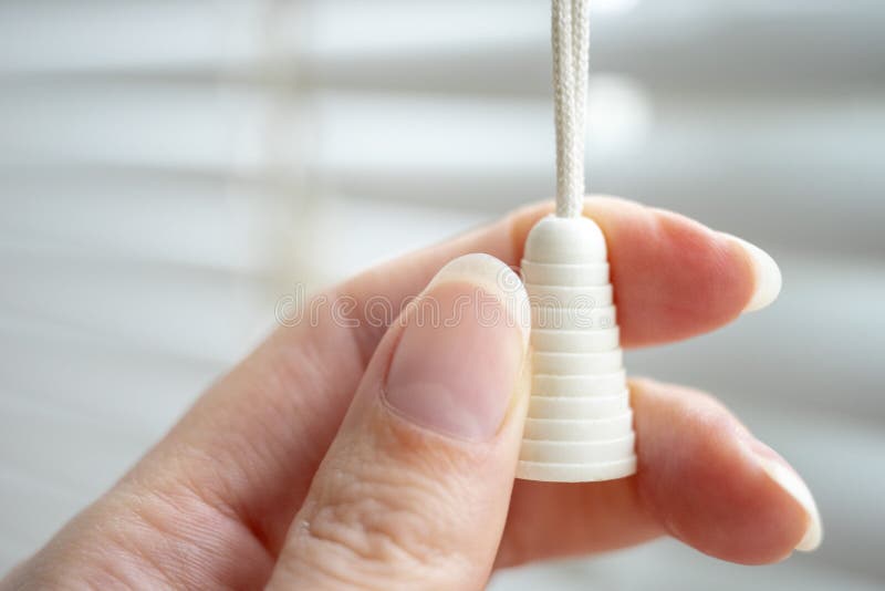 Rope Blinds with Plastic Cap in Female Fingers Close-up Stock Image ...