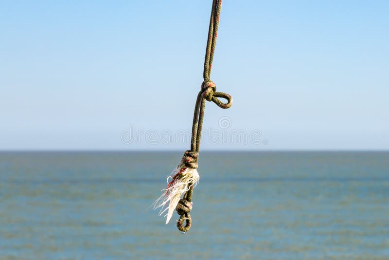 A Rope Dangling in Front of the Sea Stock Photo - Image of blurry ...