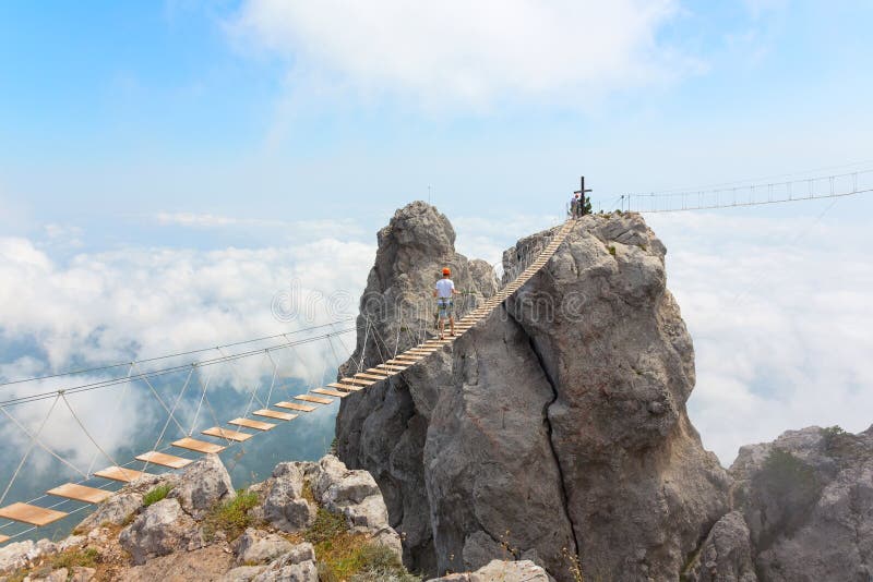Rope bridge over the chasm stock image. Image of crossing - 58989141