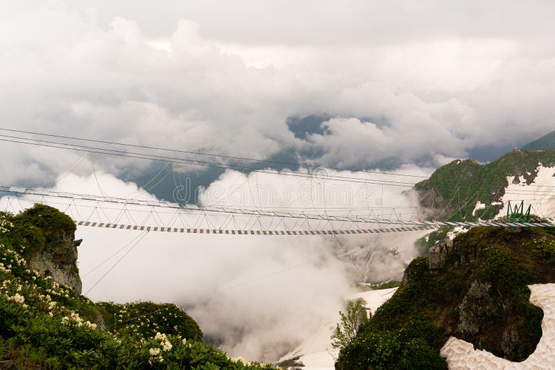 Rope Bridge in Sochi Mountains Against the Backdrop of Clouds in Rosa ...