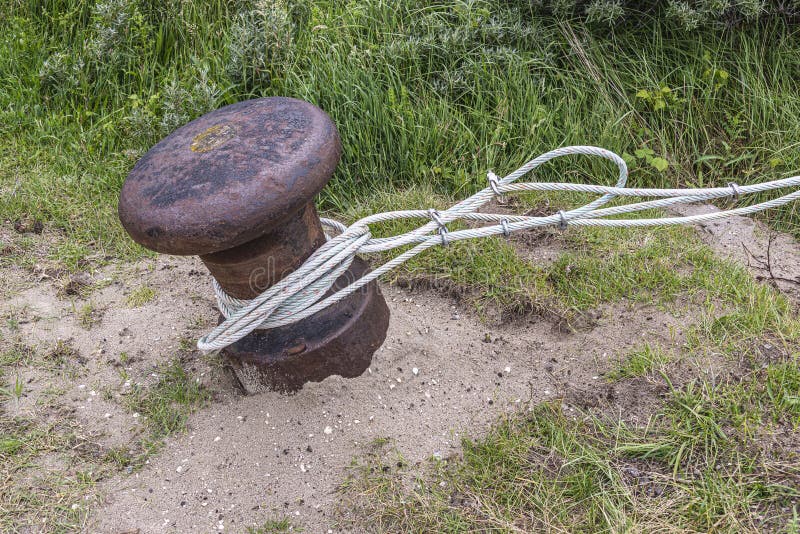Rope Cable Wrapped Around a Rusty Bollard Stock Photo - Image of coast ...