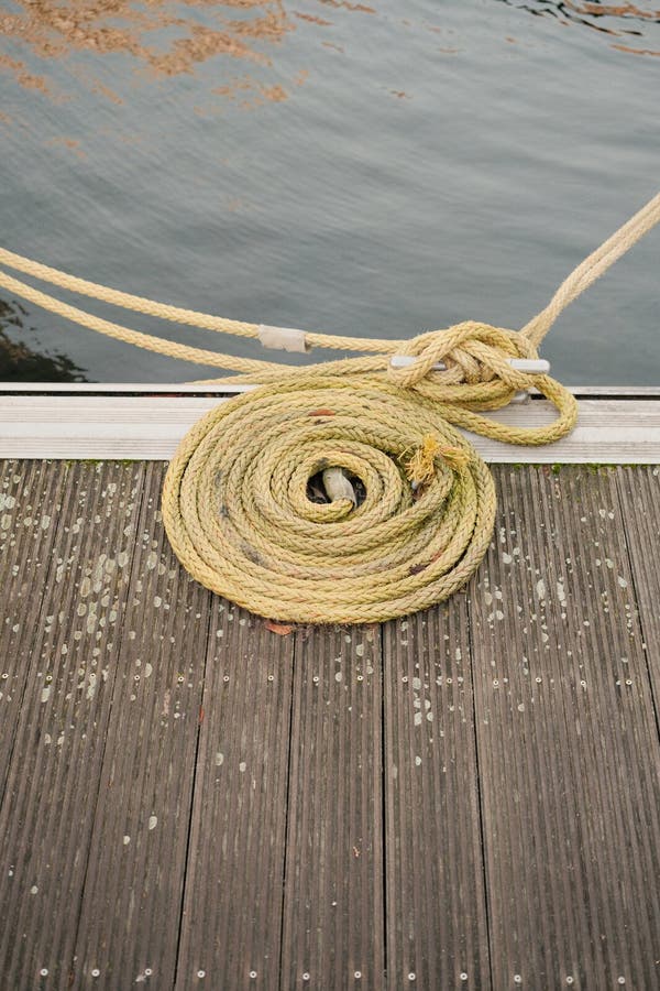 Rope Coiled on a Wooden Pier Stock Image - Image of secured, rustic ...
