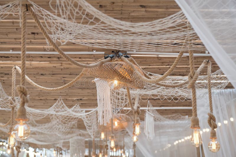 Rope Hanging Light Bulbs and White Thread Net on Bamboo Ceiling Stock ...